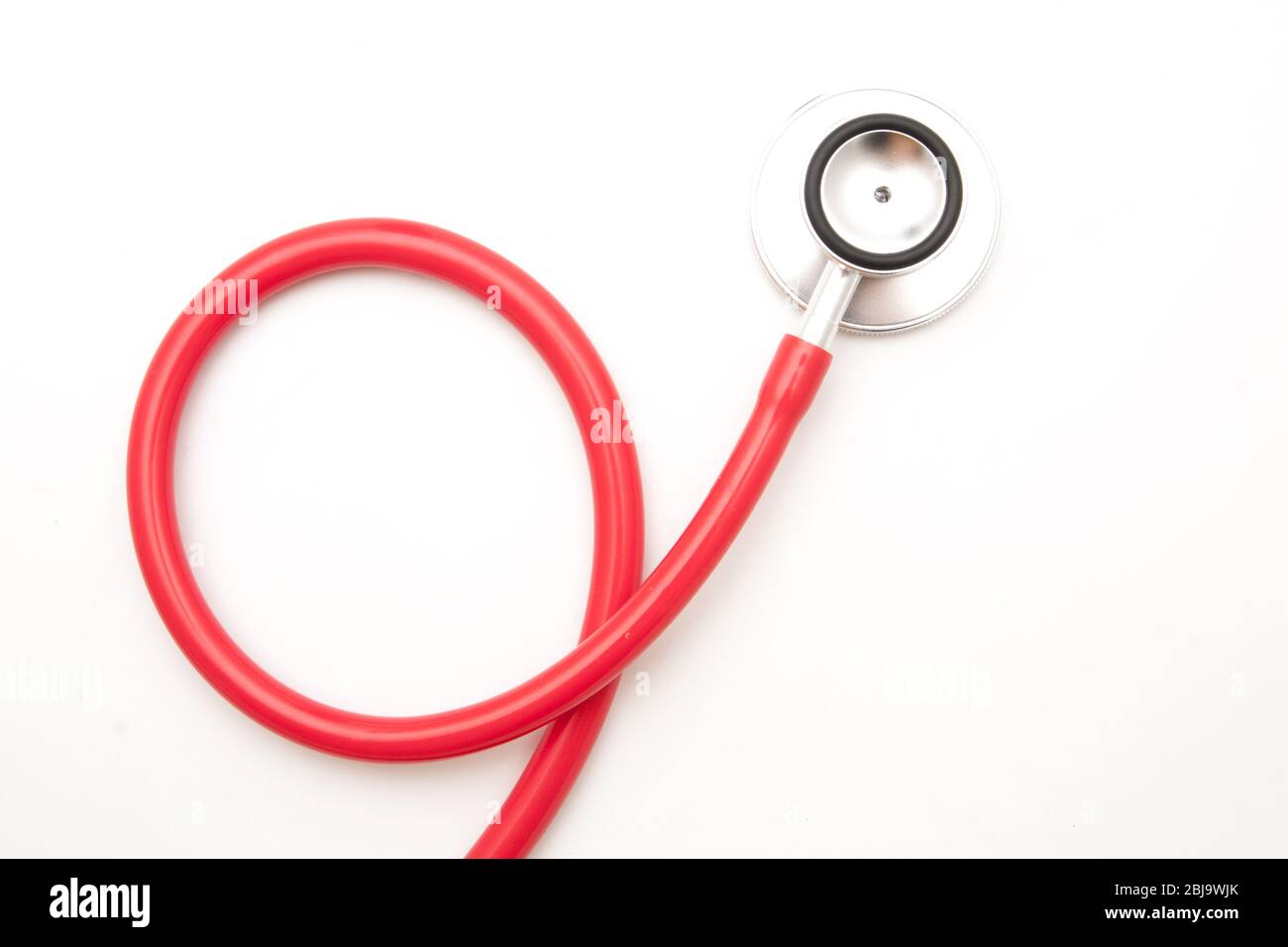 Close -up red stethoscope on white background Stock Photo - Alamy