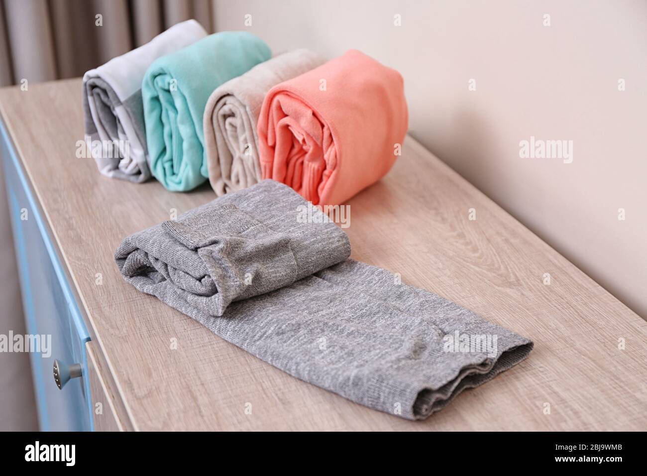 Stack of clothes on table Stock Photo - Alamy