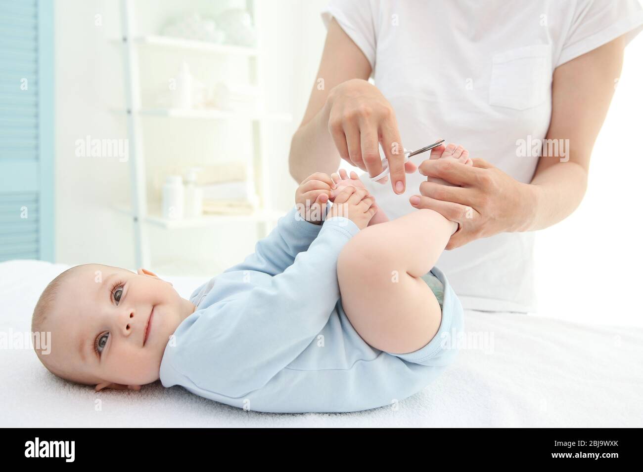 Mother cutting kids nails Stock Photo - Alamy