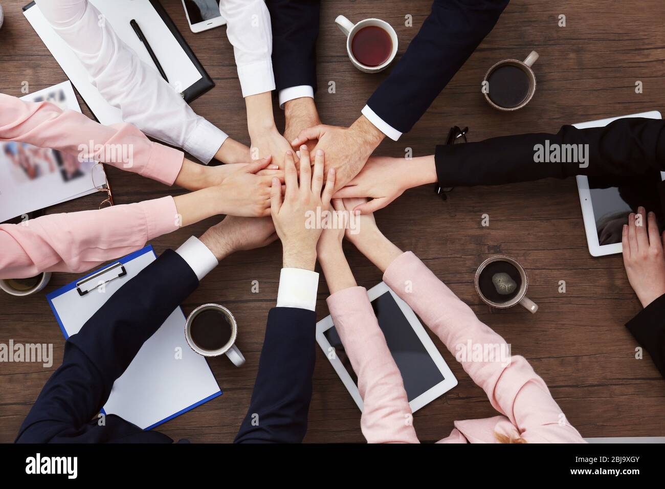 Business people hands over table. Team work concept Stock Photo - Alamy