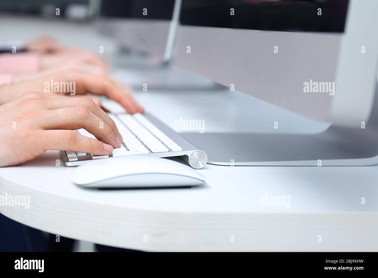 Row of computers office people hi-res stock photography and images - Alamy