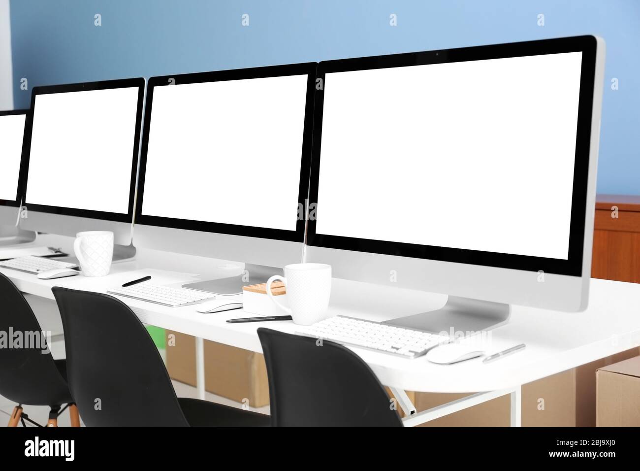 Row of computers in office Stock Photo - Alamy