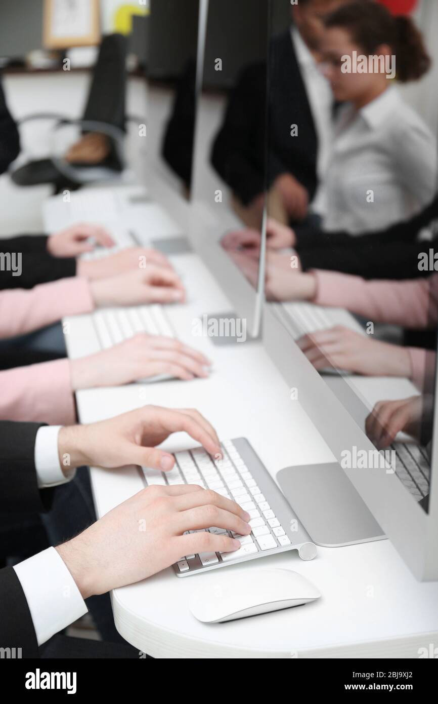Row of computers office people hi-res stock photography and images - Alamy