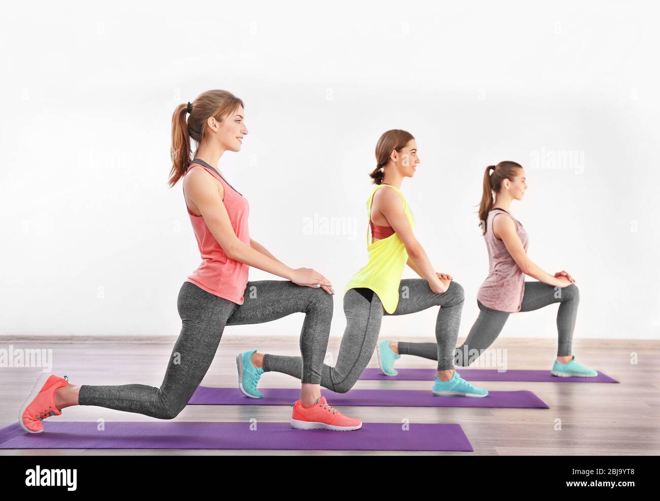 Young women doing exercise in gym Stock Photo - Alamy