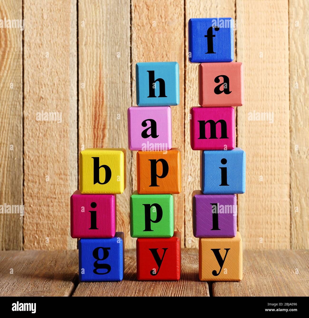 Colourful words BIG HAPPY FAMILY on wooden background Stock Photo - Alamy