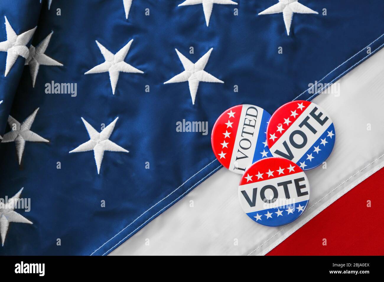 American vote badges on national flag background Stock Photo - Alamy