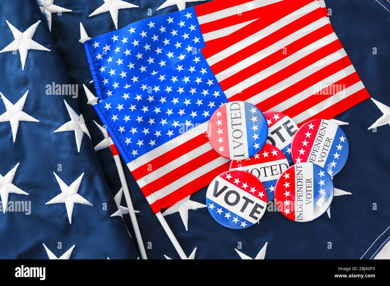 American vote badges on national flag background Stock Photo - Alamy