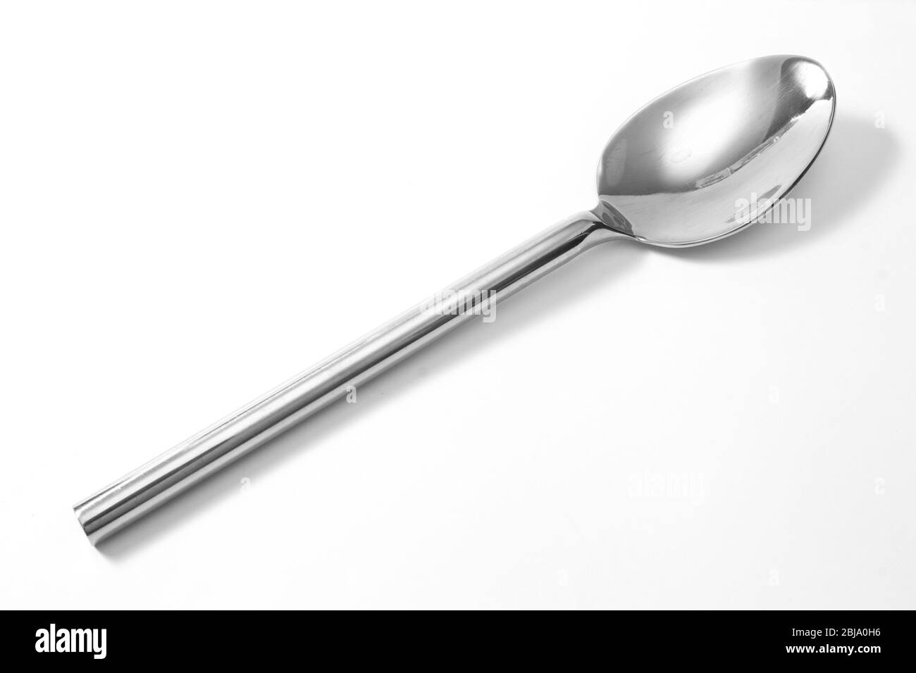 Stainless steel glossy metal kitchen spoon isolated over the white ...