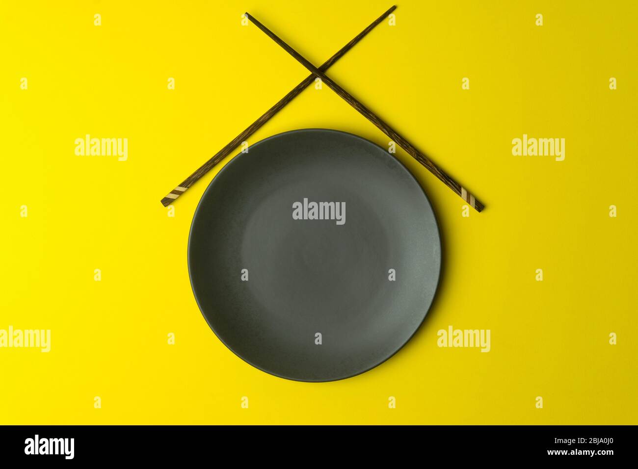 Empty plate on a yellow background. Empty plate for asian and chinese ...