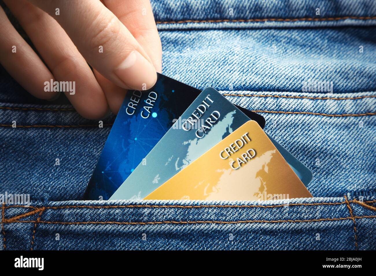 Female hand putting credit card in pocket Stock Photo - Alamy