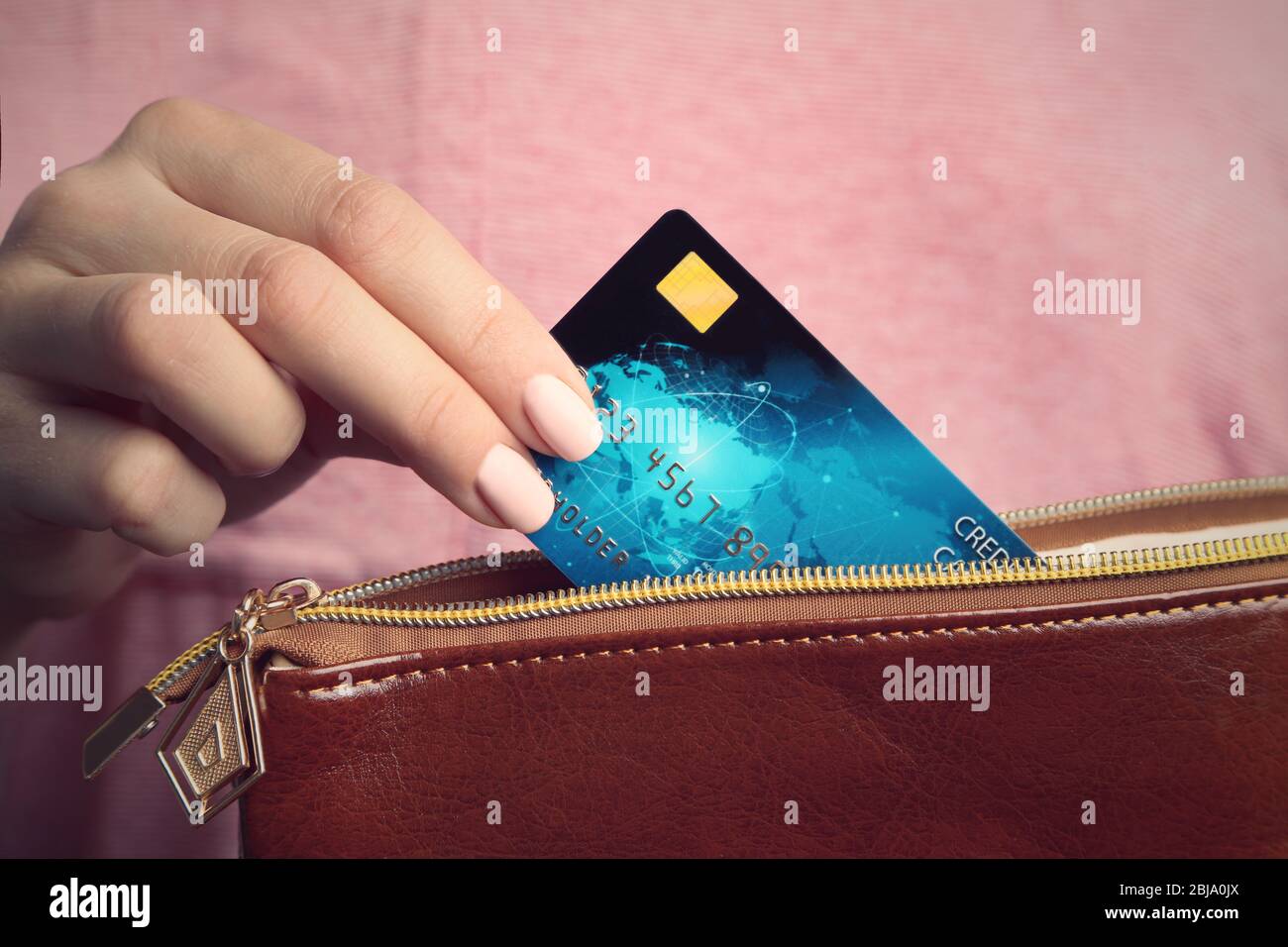 Female hand putting credit card in wallet Stock Photo - Alamy