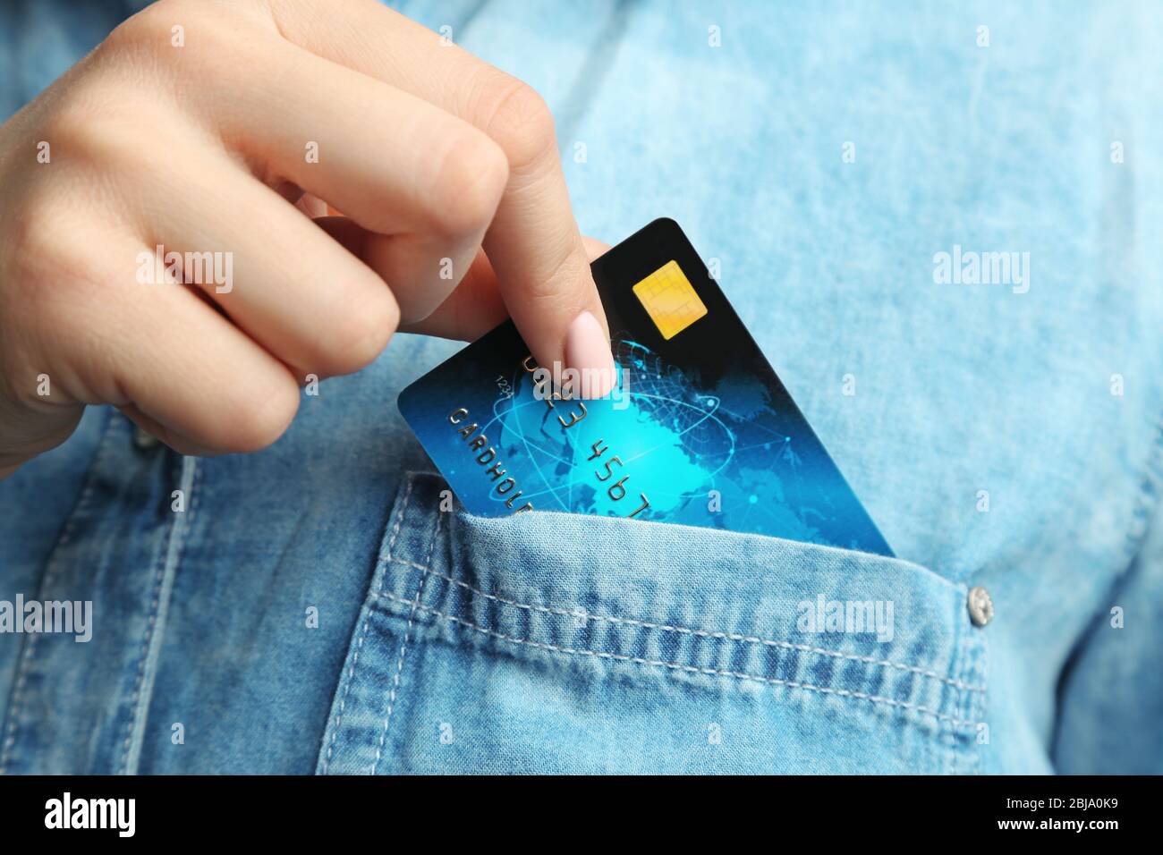 Female hand putting credit card in pocket Stock Photo - Alamy
