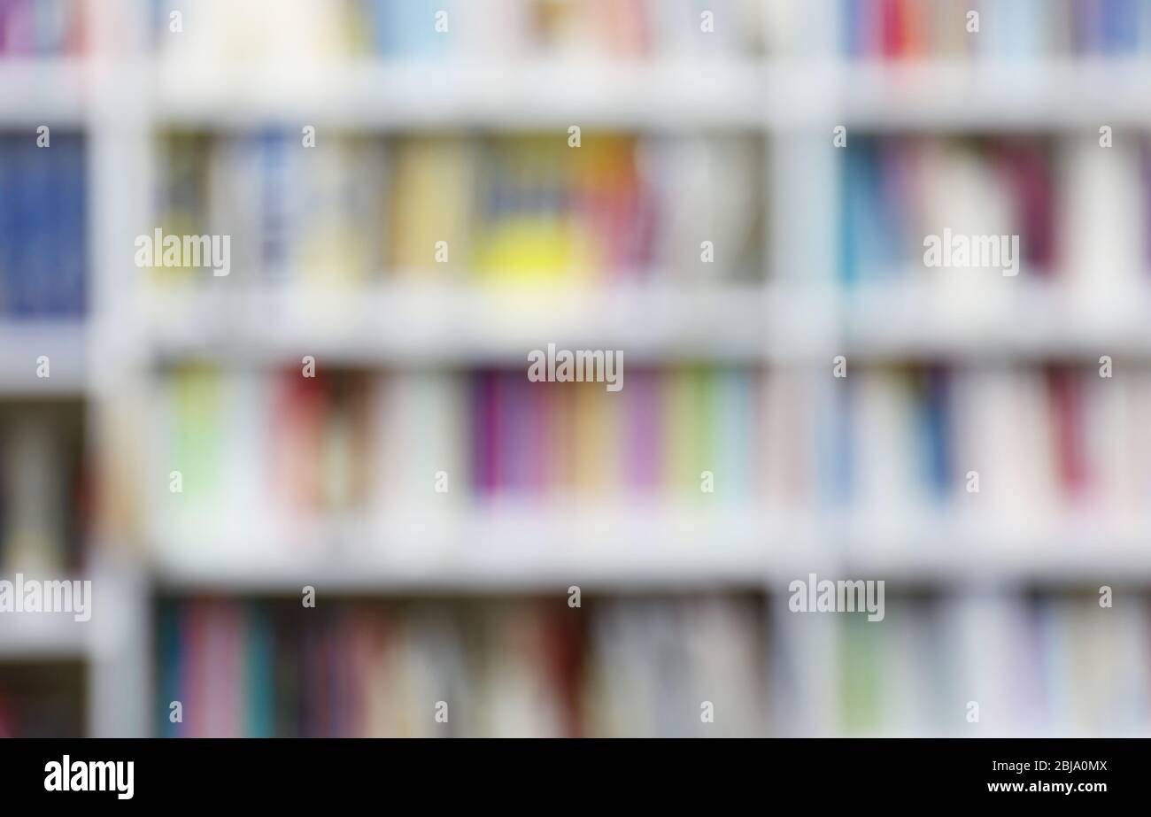 Modern library. Bookshelves full of books, unfocused Stock Photo - Alamy