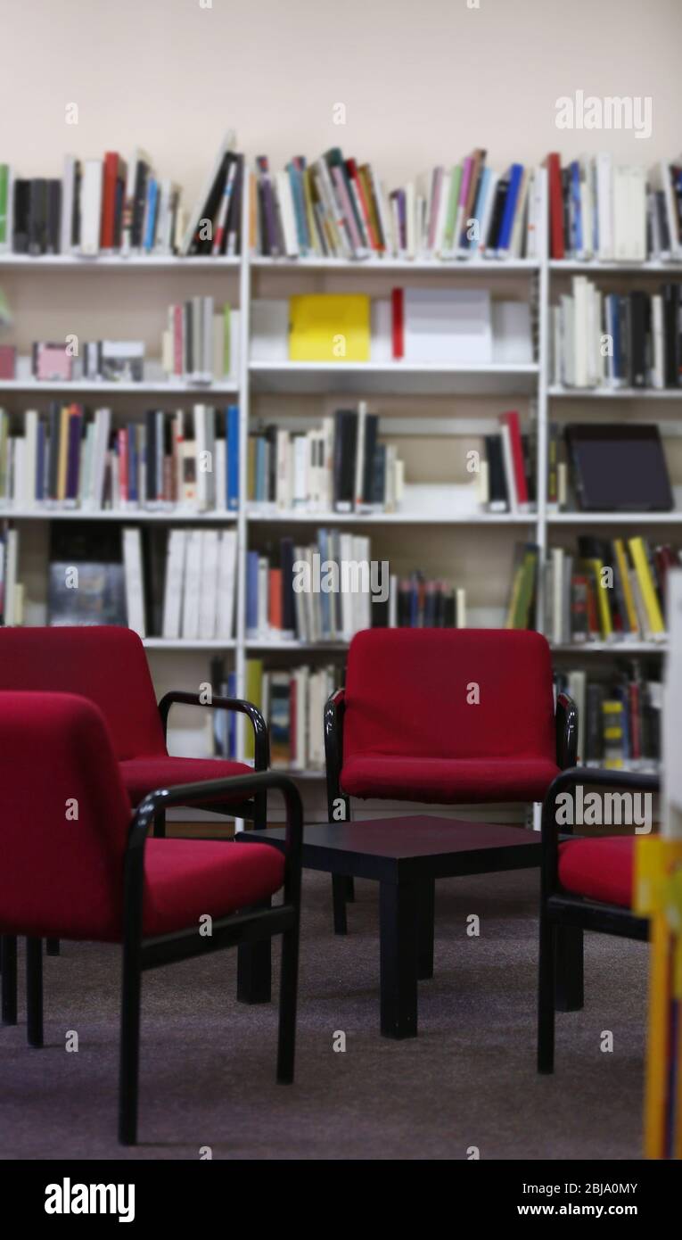 Modern library interior with red chairs Stock Photo - Alamy