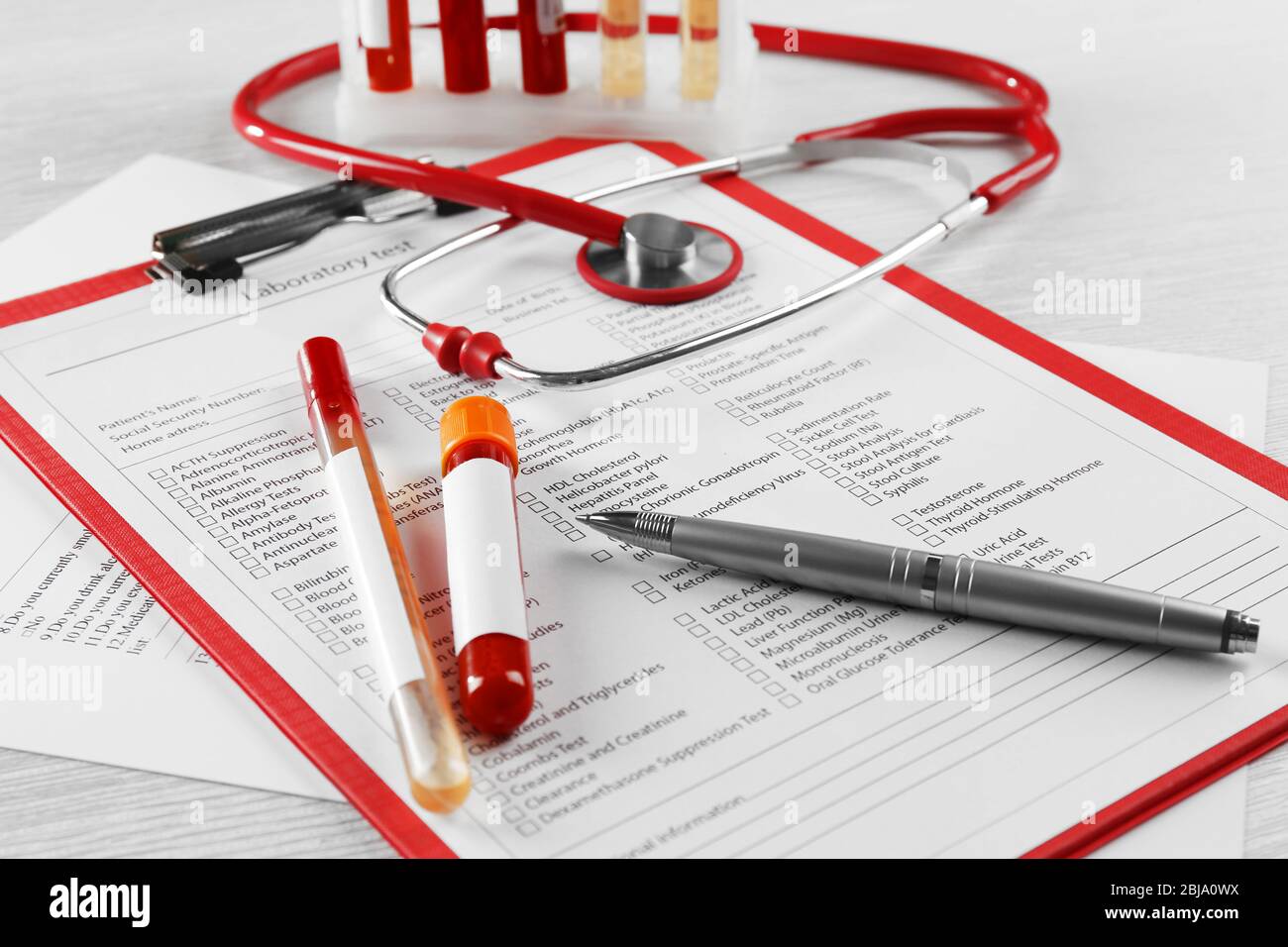 Blood samples and stethoscope on medical report Stock Photo - Alamy