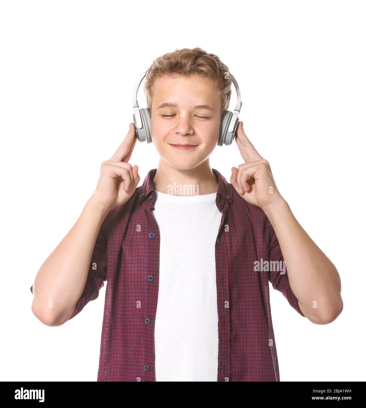 Boy listening music on light background Stock Photo - Alamy