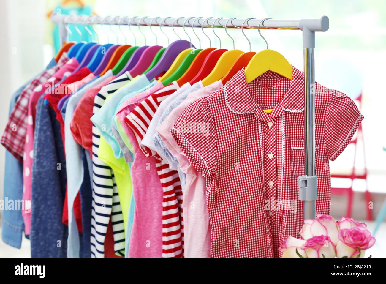 Children clothes hanging on hangers in the shop Stock Photo - Alamy