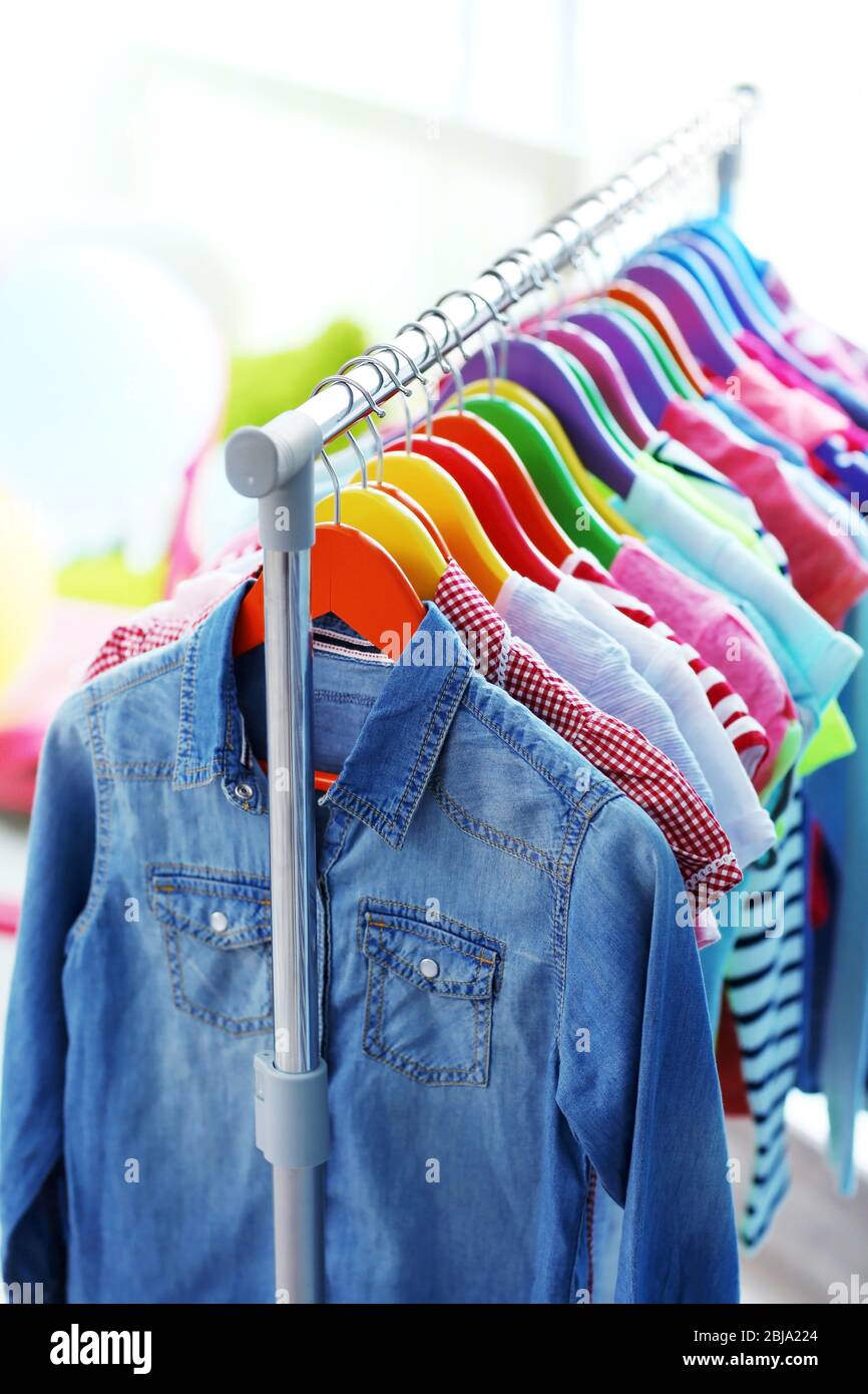 Children clothes hanging on hangers in the shop Stock Photo - Alamy