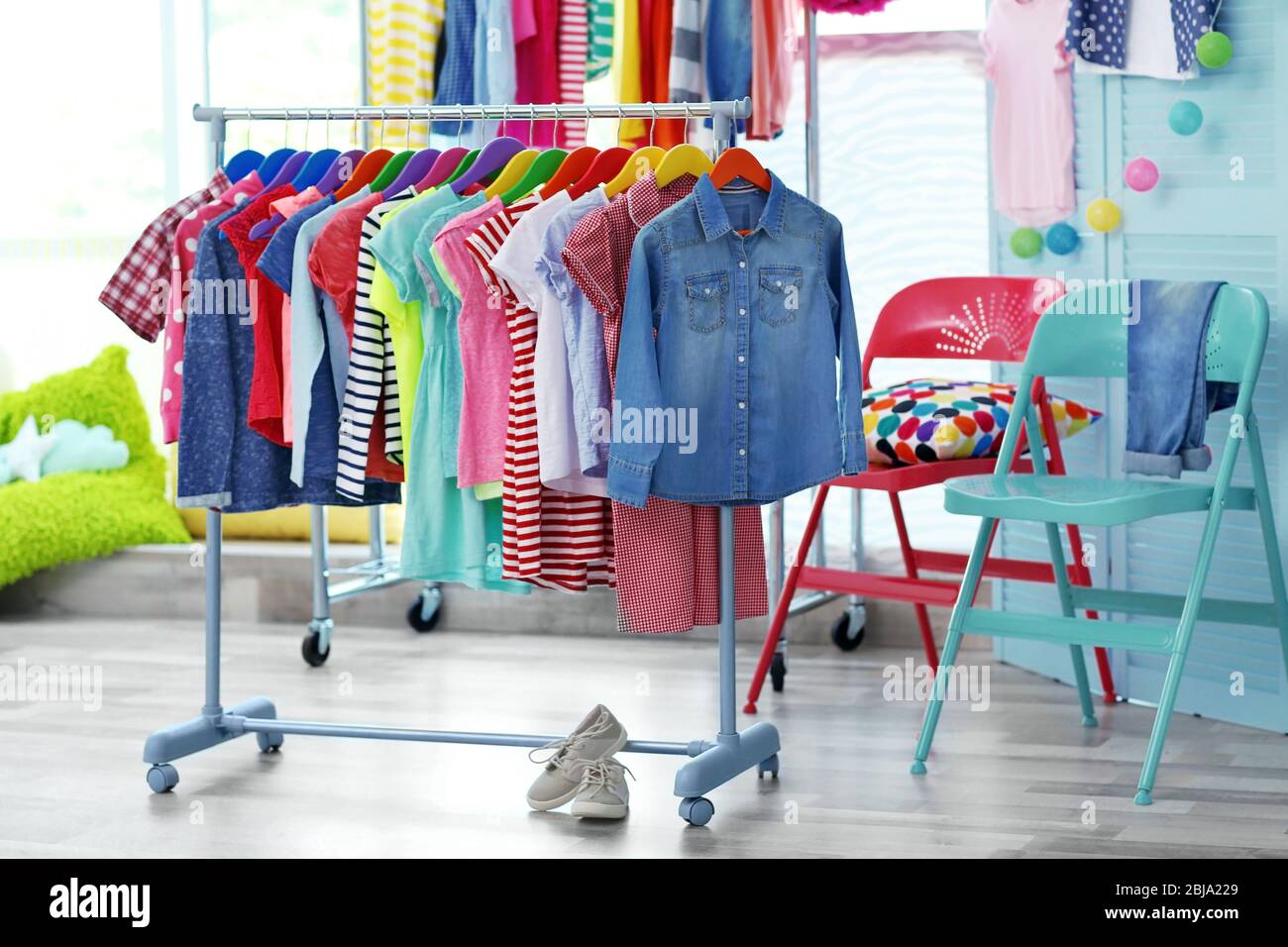 Children clothes hanging on hangers in the shop Stock Photo - Alamy
