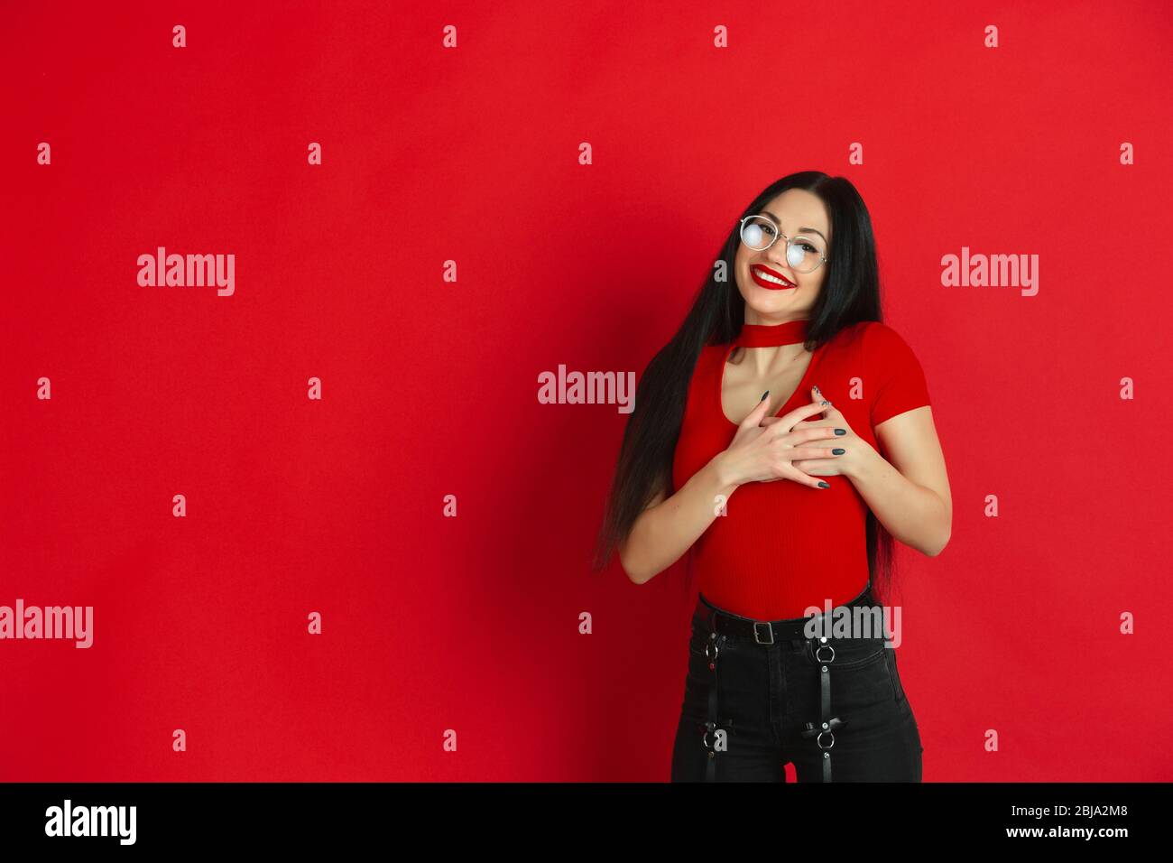 Embarrassed, thankful smiling. Caucasian young woman's monochrome ...