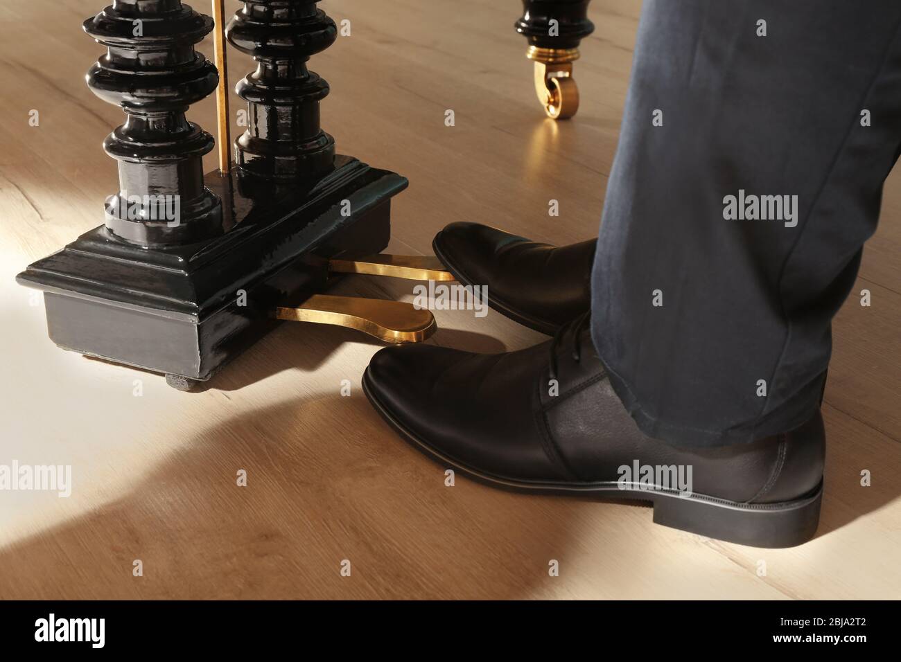 Man feet while playing piano Stock Photo - Alamy