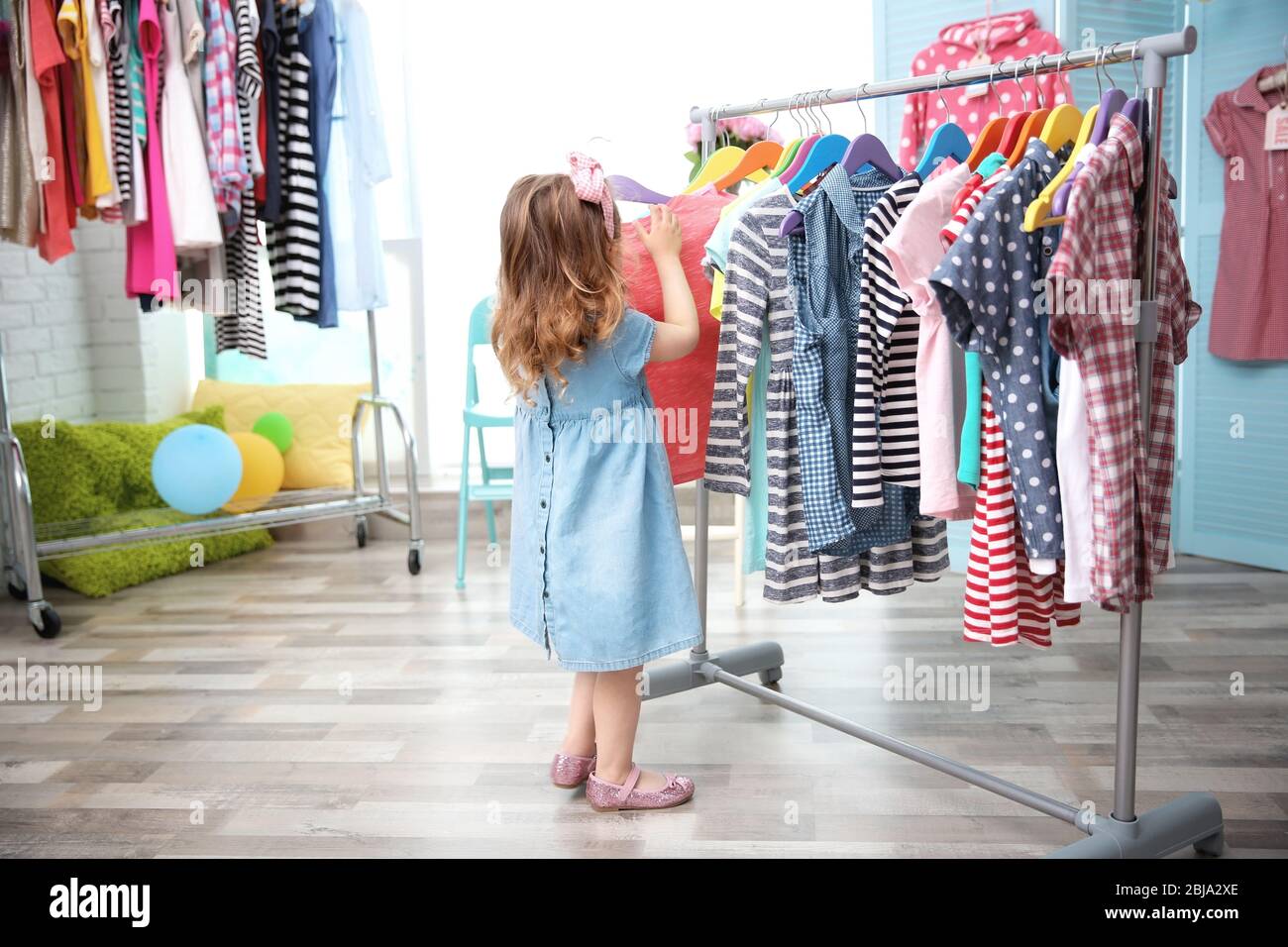 Cute baby girl in baby shop store Stock Photo - Alamy