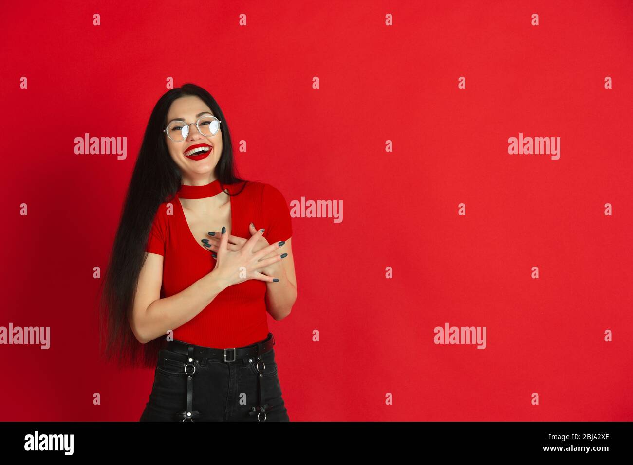 Embarrassed, thankful smiling. Caucasian young woman's monochrome ...