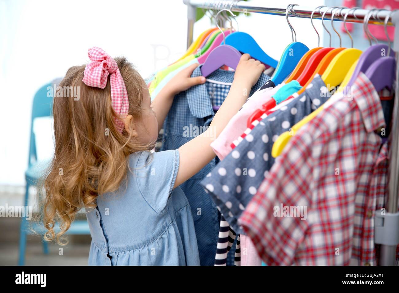 Cute baby girl in baby shop store Stock Photo - Alamy