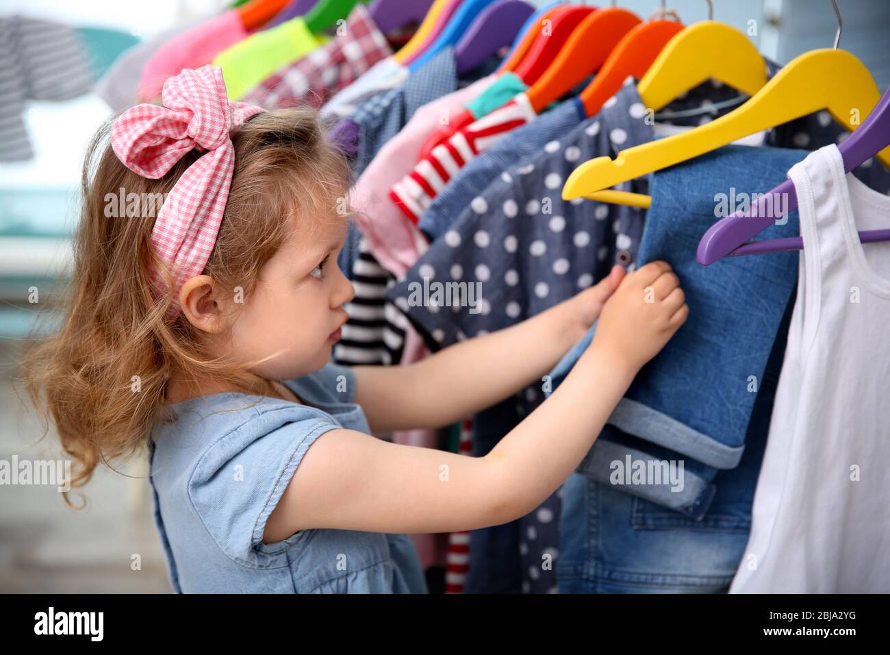 Cute baby girl in baby shop store Stock Photo - Alamy