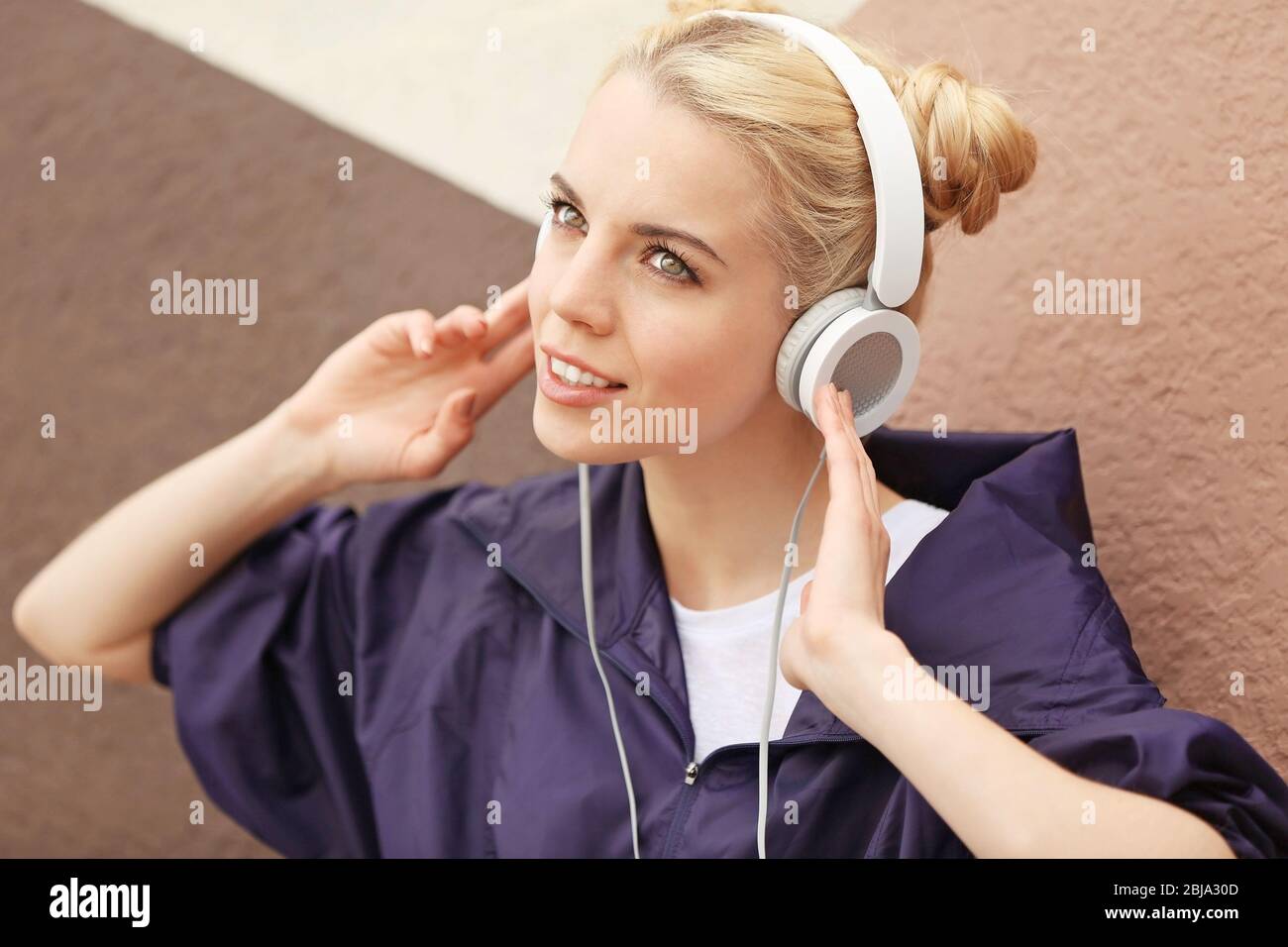 Beautiful girl listening music on street Stock Photo - Alamy