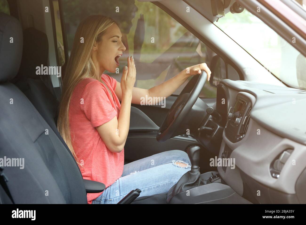Young woman falling asleep in car Stock Photo - Alamy