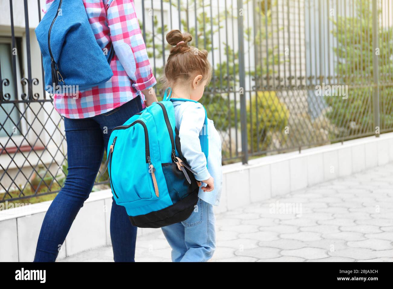 Parent taking child to school Stock Photo - Alamy
