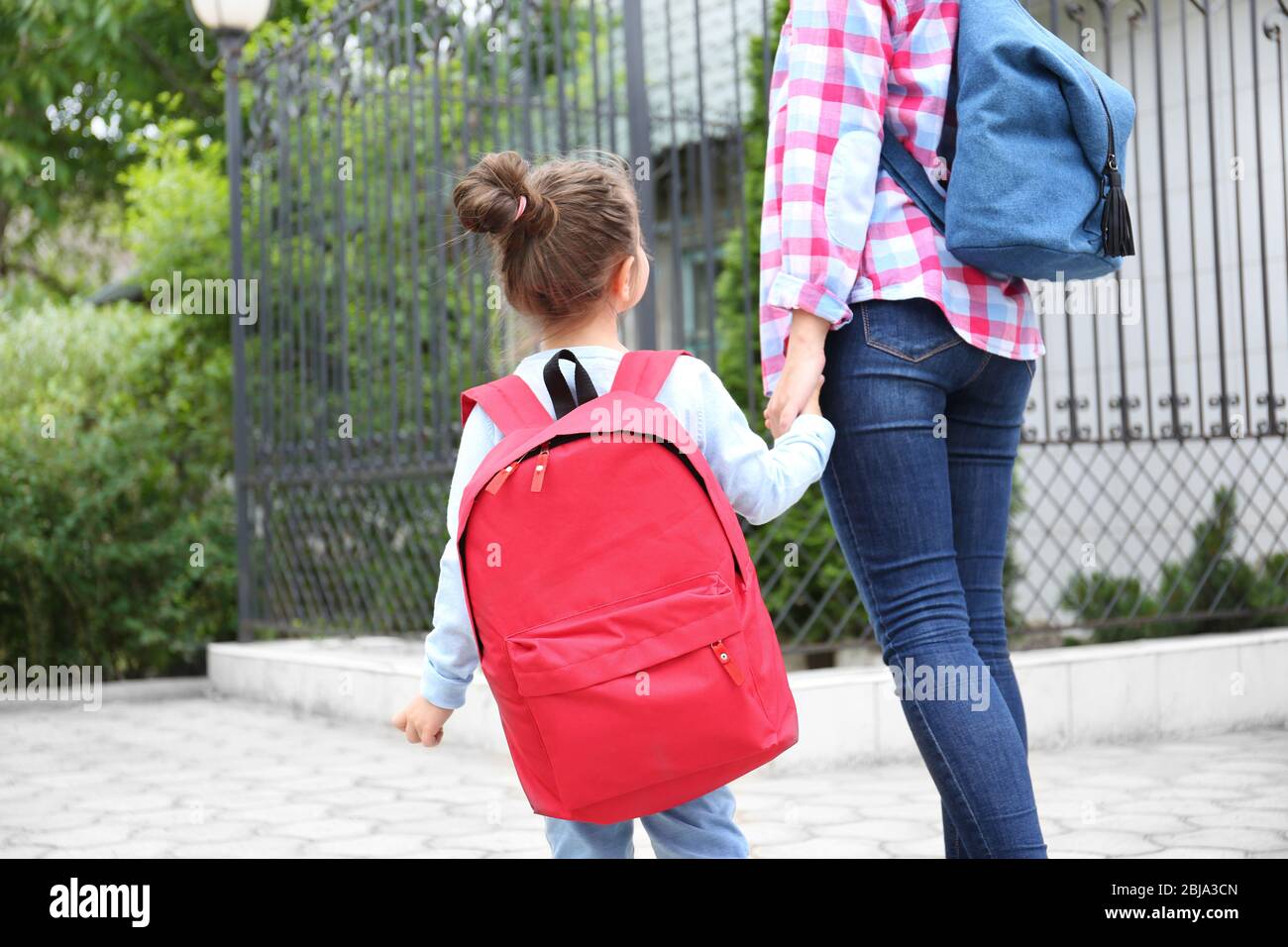 Parent taking child to school Stock Photo - Alamy