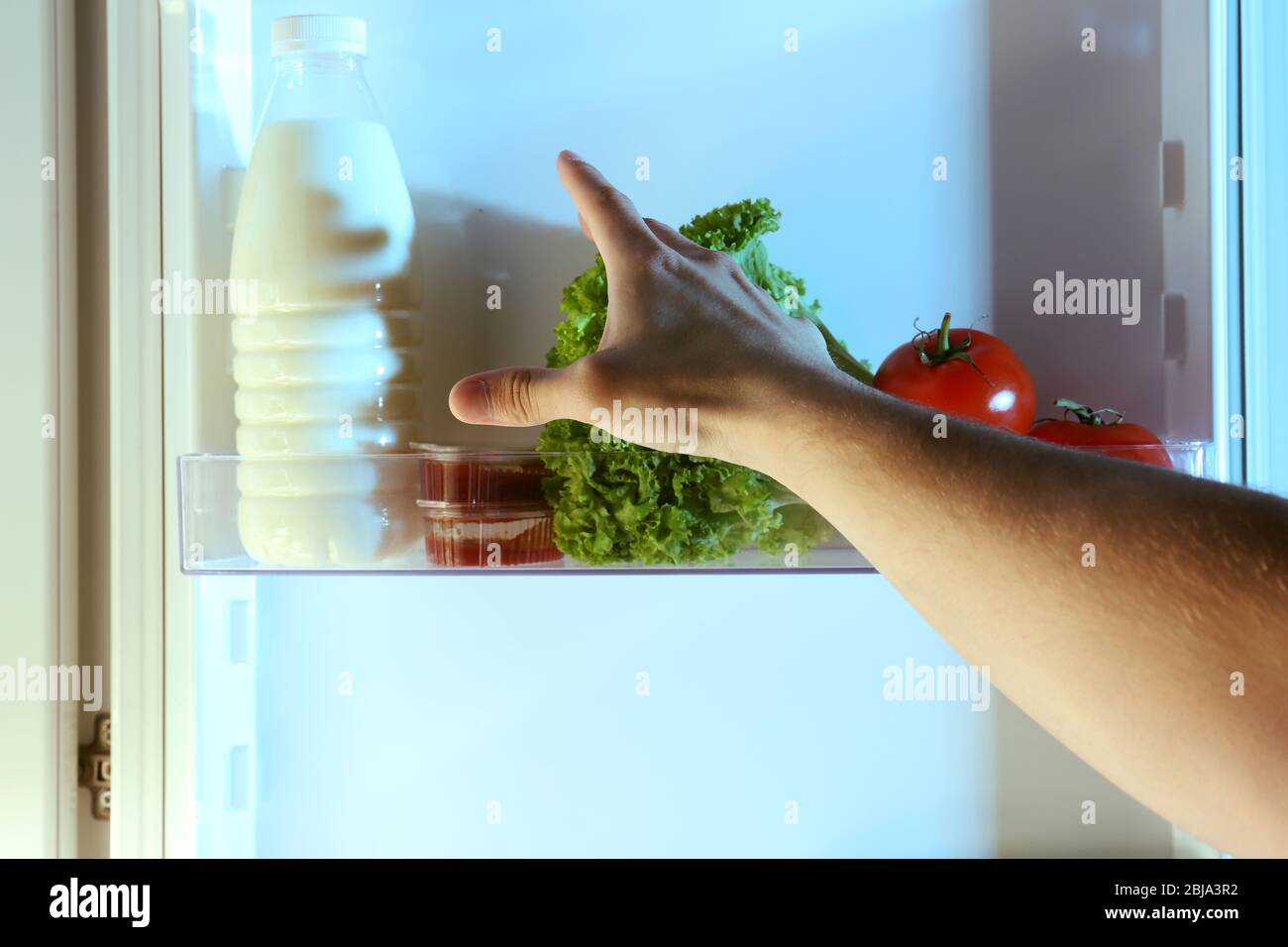 Male hand choosing food in kitchen. Hunger concept Stock Photo - Alamy
