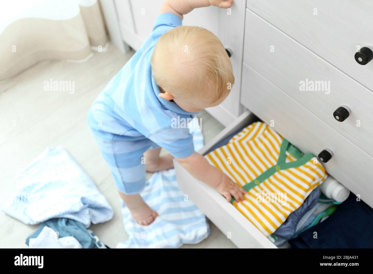 Kid tidy up clothes hi-res stock photography and images - Alamy