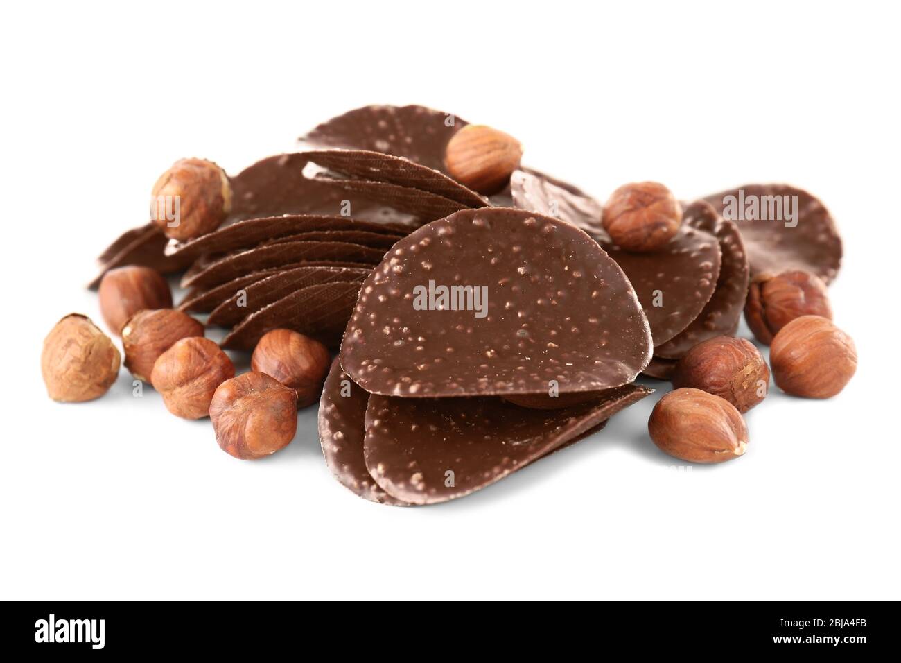 Chocolate chips and hazelnuts on white background Stock Photo - Alamy
