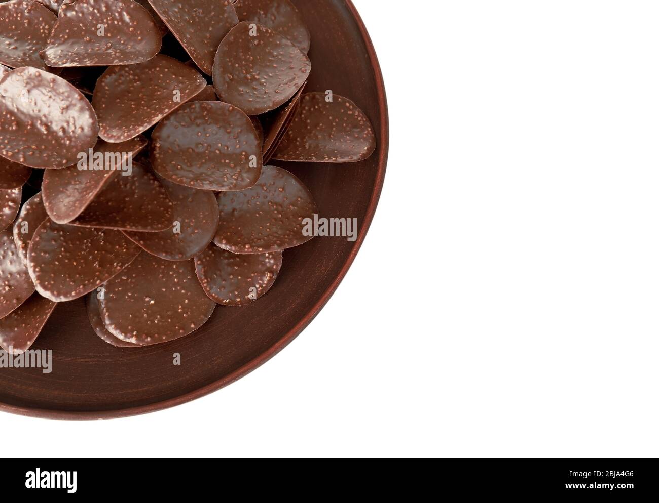 Chocolate chips in brown plate on white background Stock Photo - Alamy