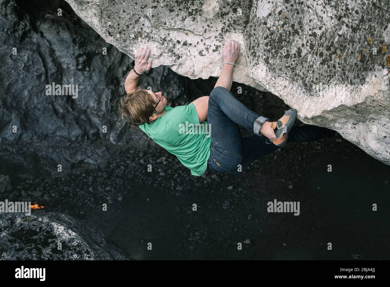 Man is making a strong boulder in Góry Towarne. Bouldering in ...