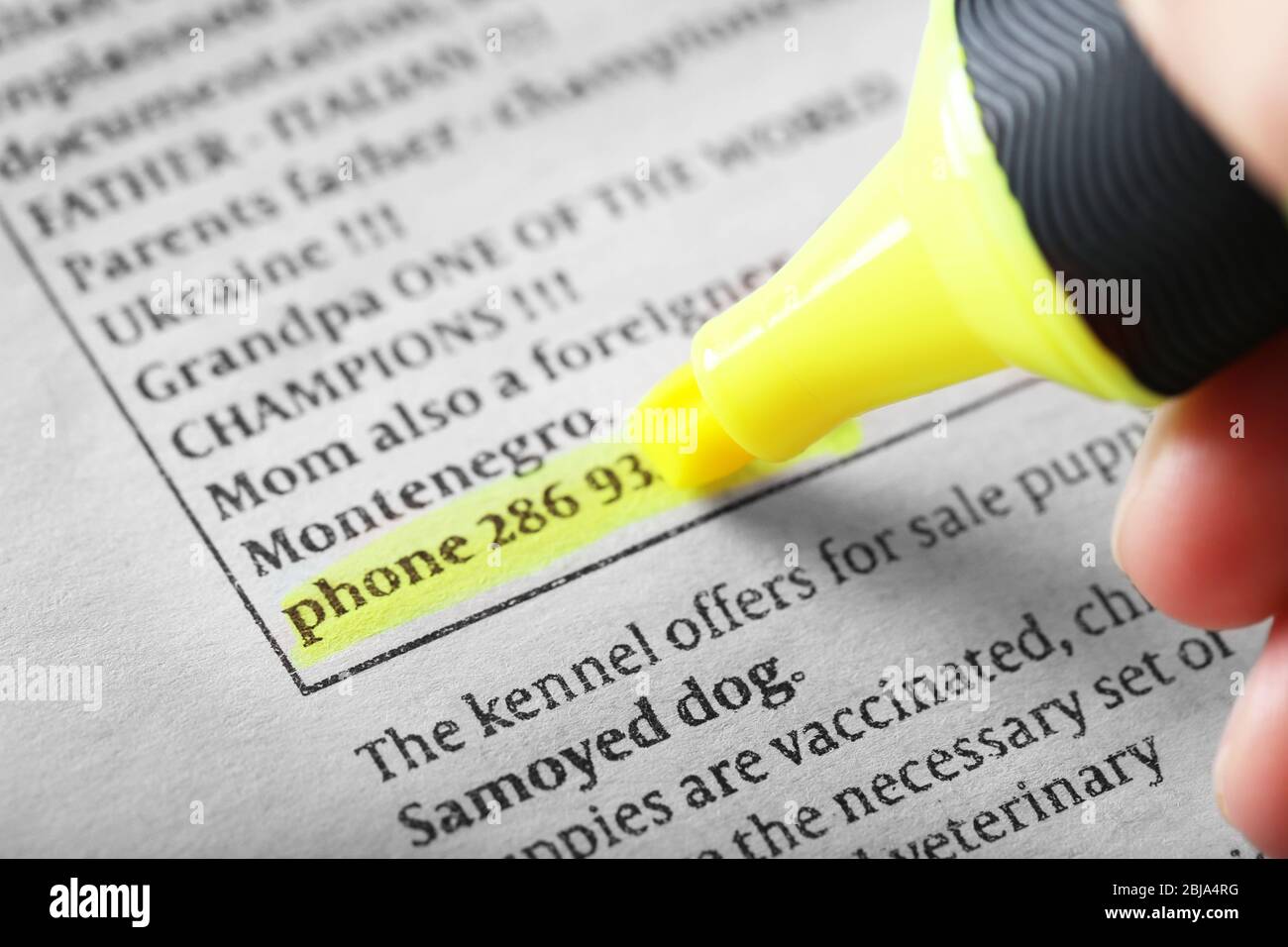 Search newspaper advertisements for information Stock Photo - Alamy
