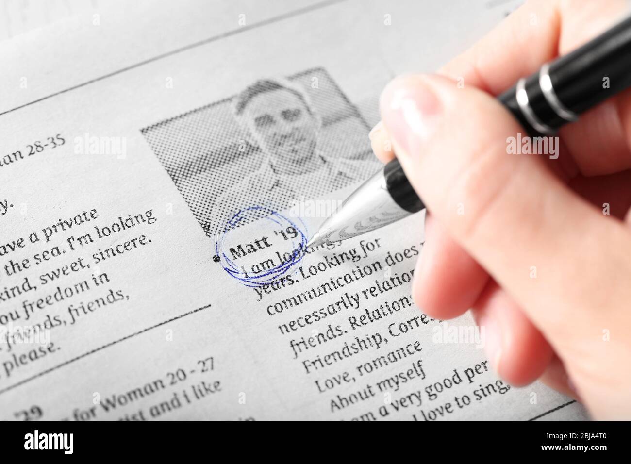 Search newspaper advertisements for information Stock Photo - Alamy