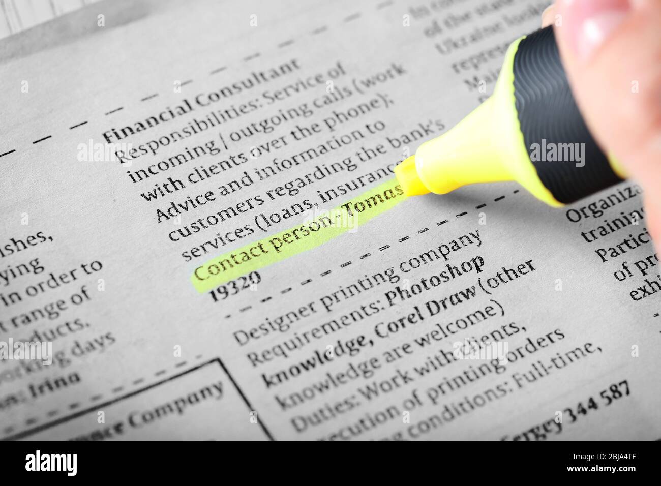 Search newspaper advertisements for information Stock Photo - Alamy