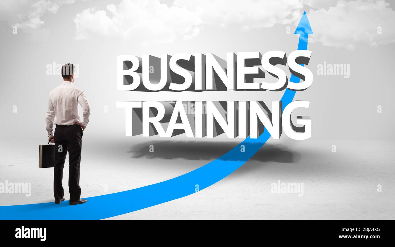Rear view of a businessman standing in front of BUSINESS TRAINING ...