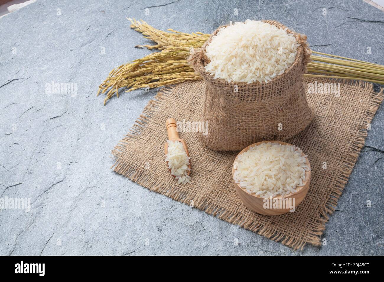 thai fragrant jasmine rice in a bowl with gold spike on Sack Stock ...