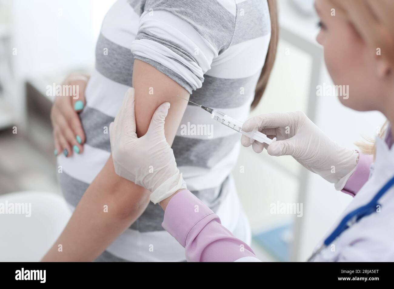 Doctor making injection a pregnant woman at the hospital Stock Photo ...