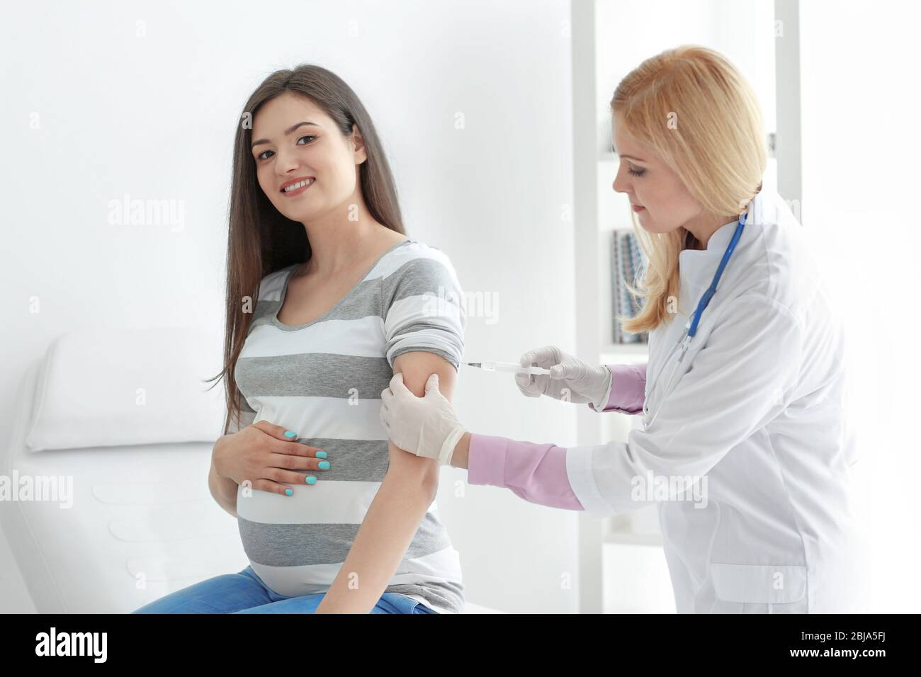 Doctor making injection a pregnant woman at the hospital Stock Photo ...