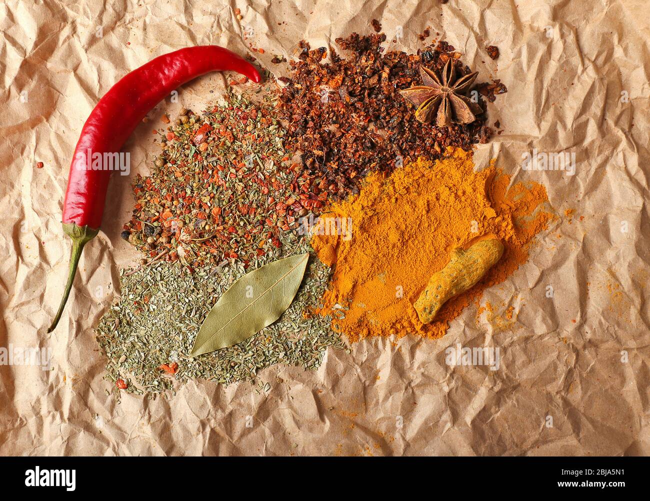 Different spices on parchment background Stock Photo - Alamy