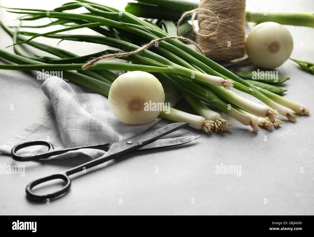 Composition of fresh onion on light background Stock Photo - Alamy