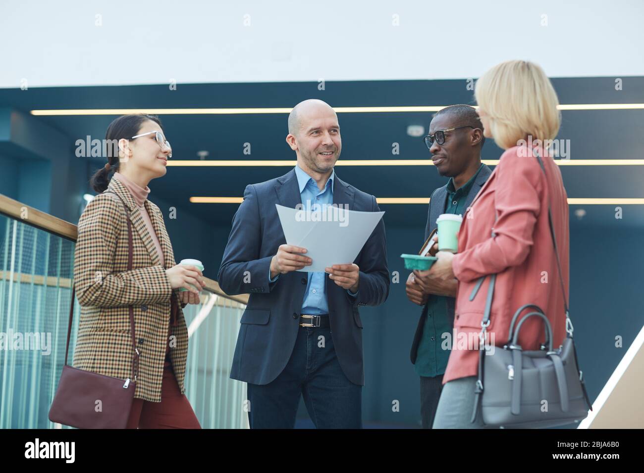 Mature businessman holding documents and giving recommendation for his ...