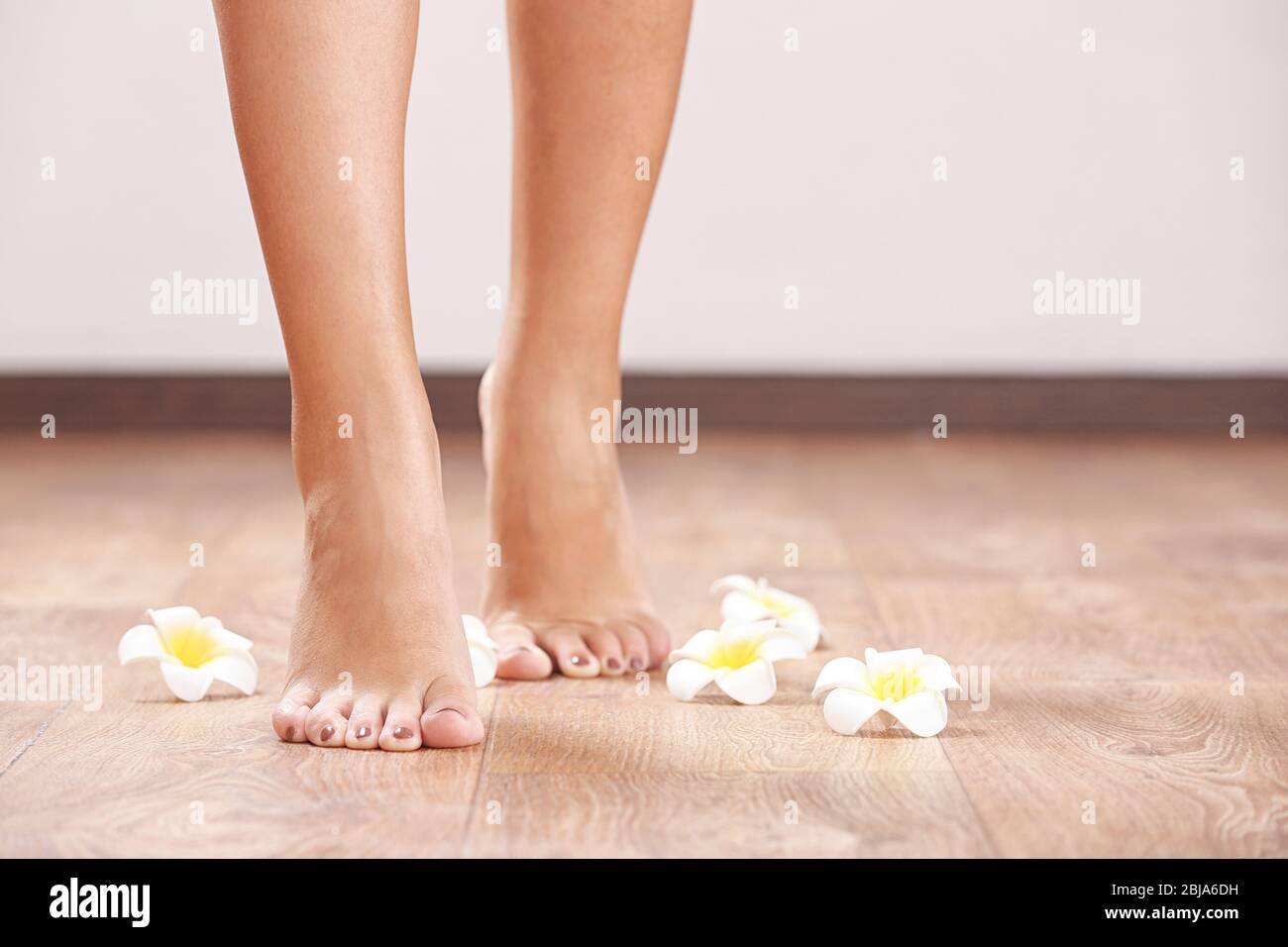 Female feet with flowers on floor Stock Photo - Alamy