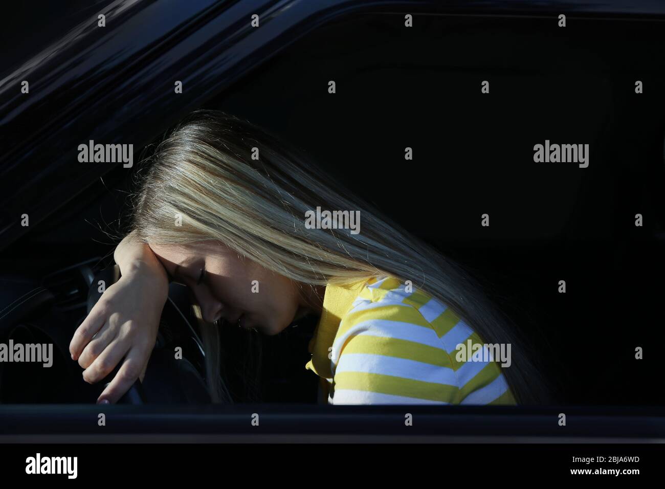 Tired beautiful woman falling asleep in car Stock Photo - Alamy